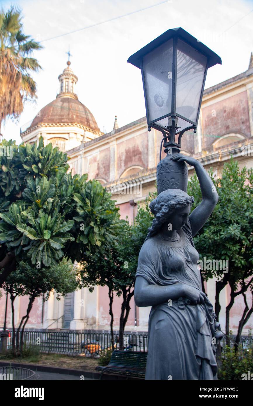 neoclassical lamp post representing a human fgure in the central square ...
