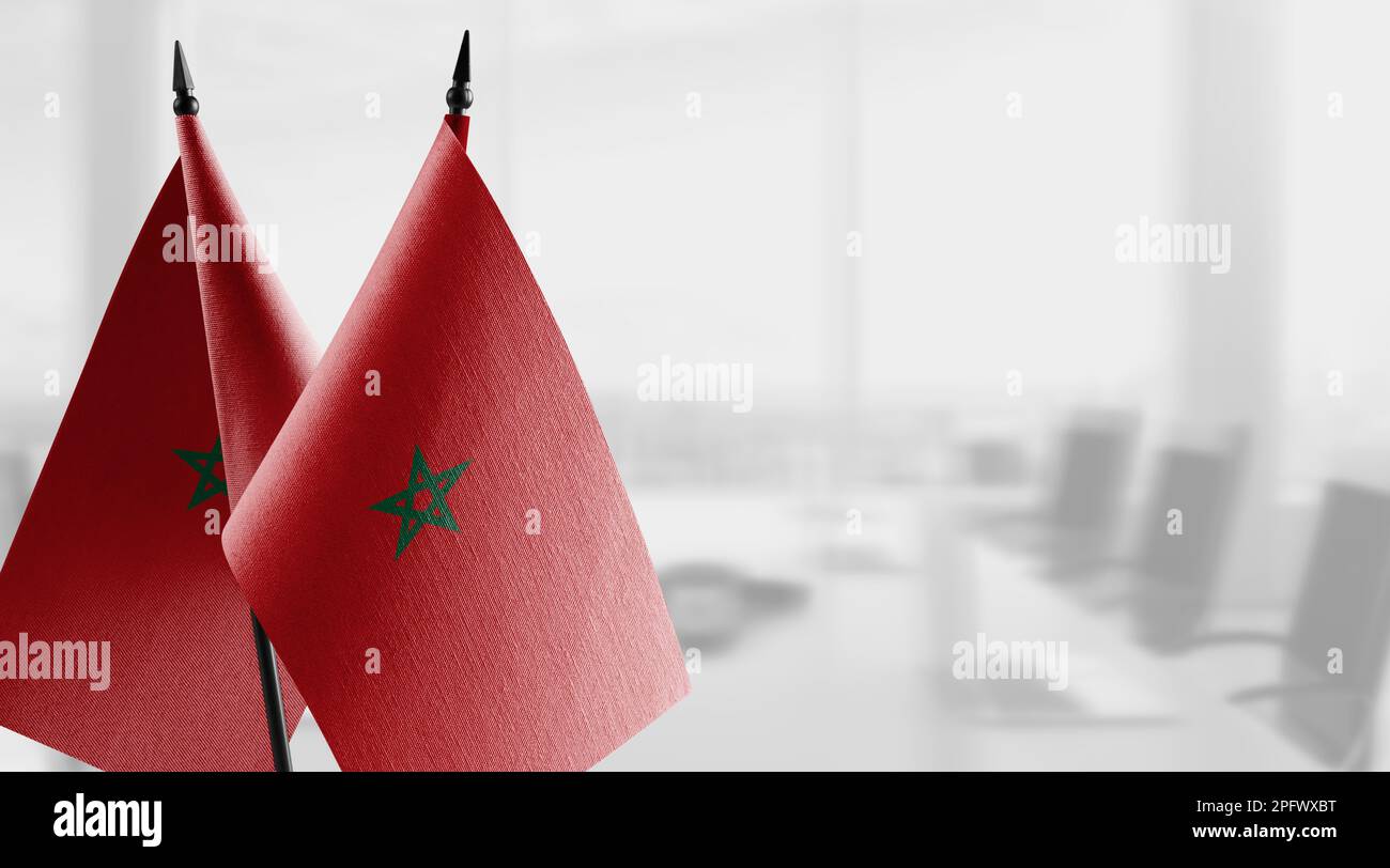 Small flags of the Morocco on an abstract blurry background Stock Photo ...