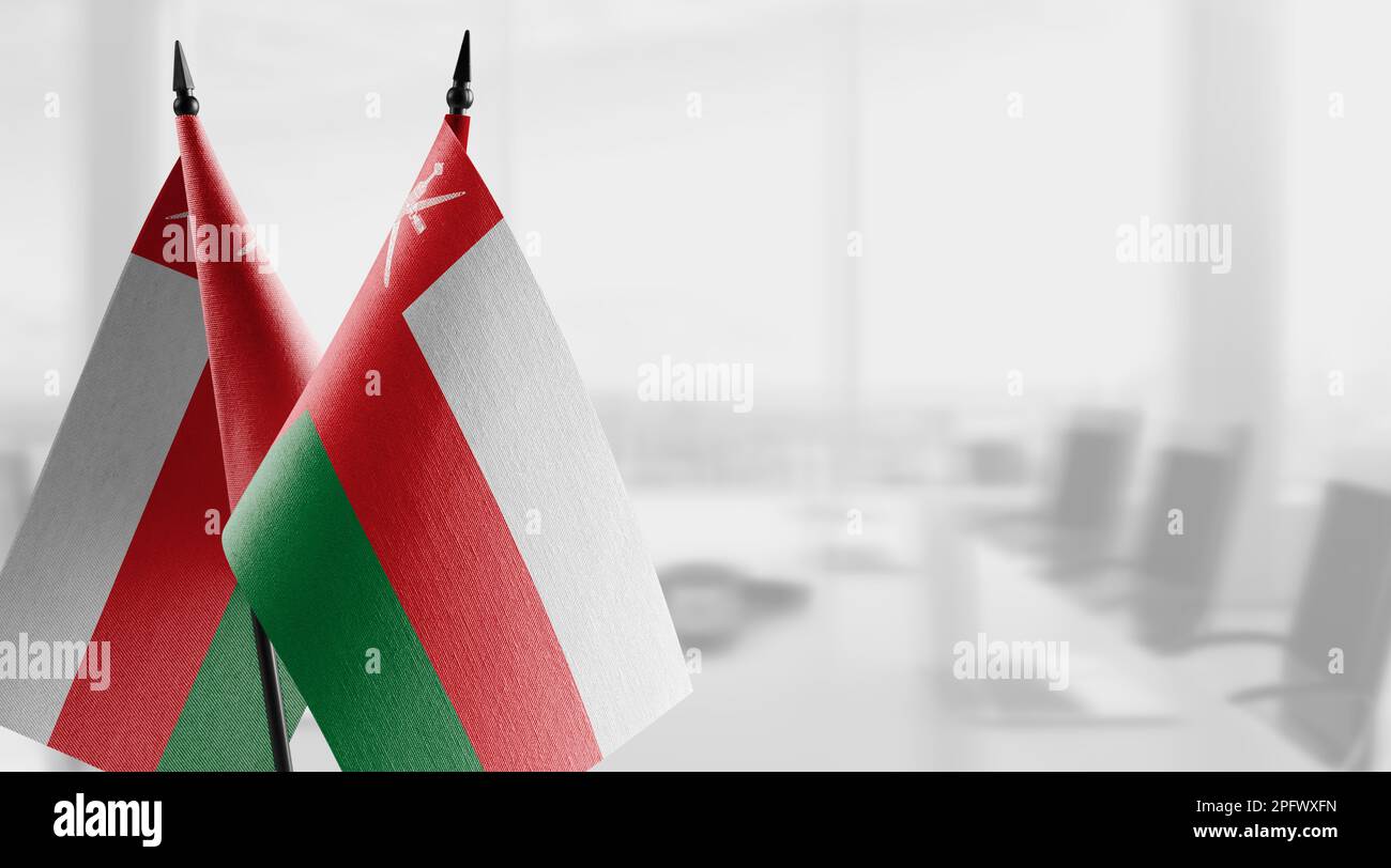 Small flags of the Oman on an abstract blurry background Stock Photo ...