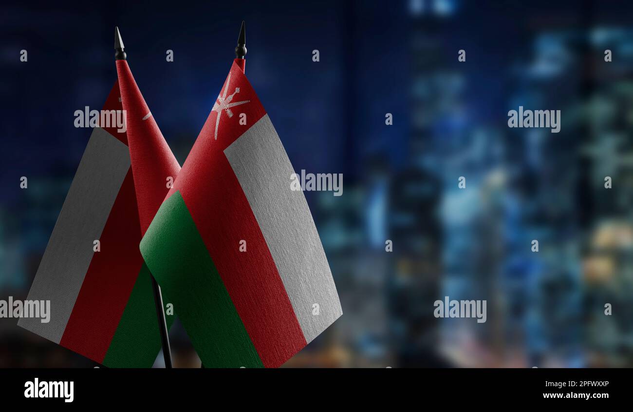 Small flags of the Oman on an abstract blurry background Stock Photo ...