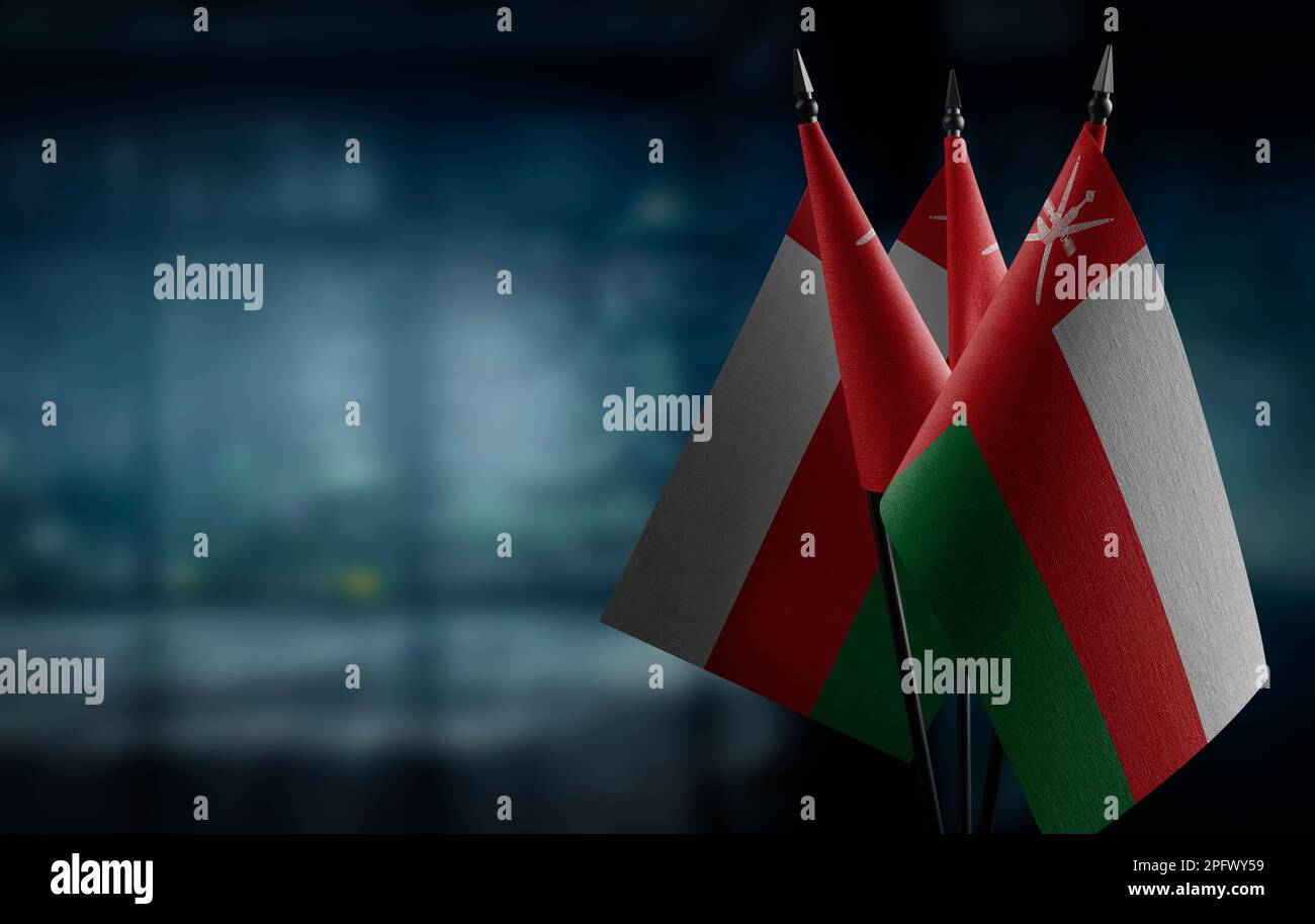 Small flags of the Oman on an abstract blurry background Stock Photo ...