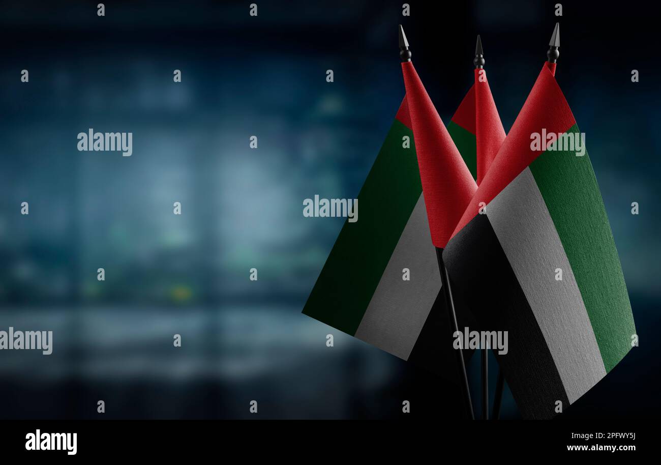 Small flags of the Arab Emirates on an abstract blurry background Stock ...