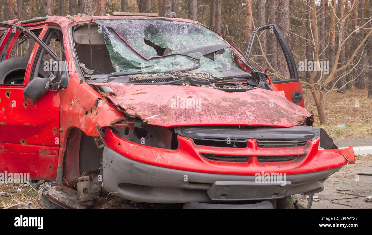 Rusty and broken red abandoned car on the city street. Abandoned old car accident outdoors. Old ...