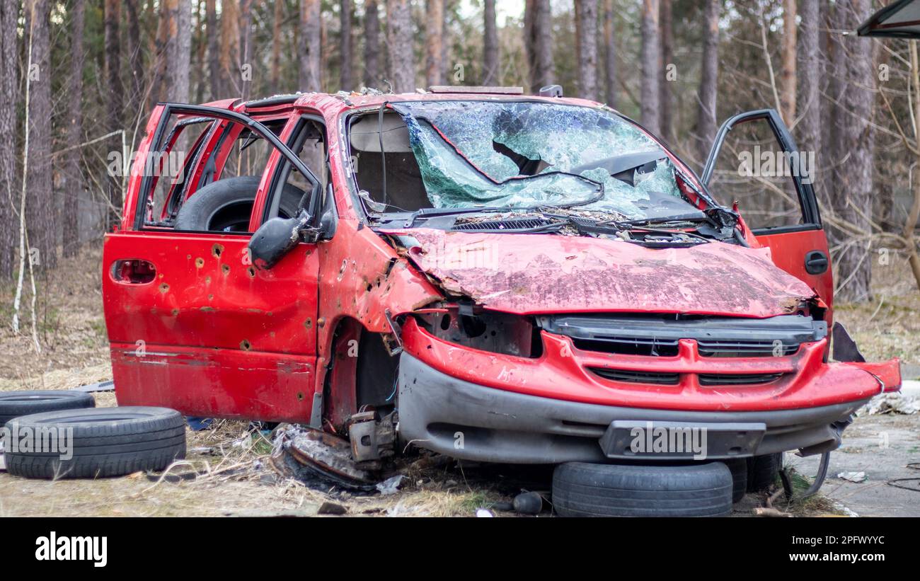 Rusty and broken red abandoned car on the city street. Abandoned old car accident outdoors. Old ...