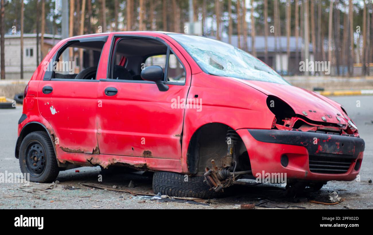 Rusty and broken red abandoned car on the city street. Abandoned old car accident outdoors. Old ...