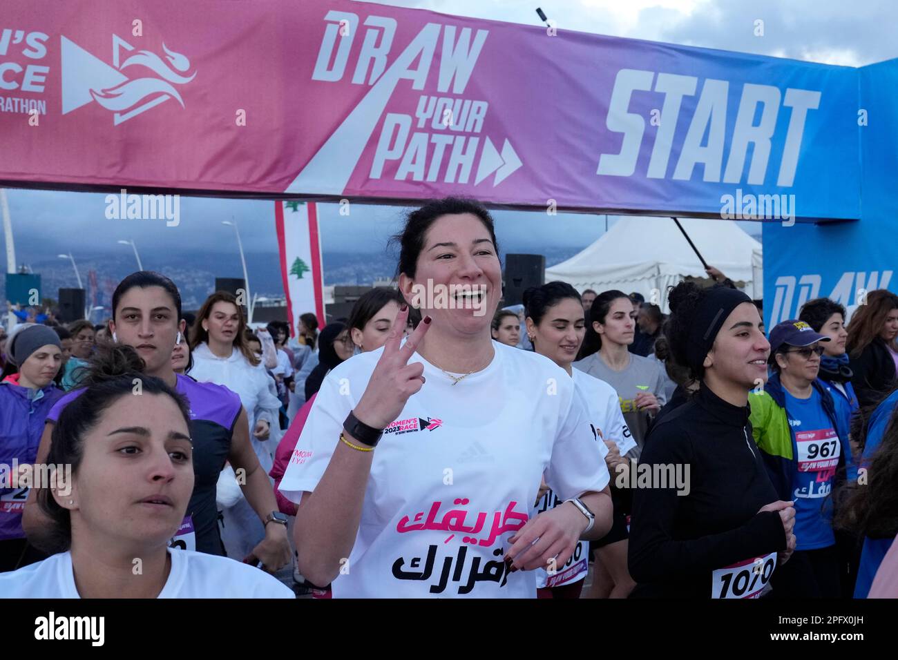 A runner gestures as she competes in the Women's Race in Beirut ...