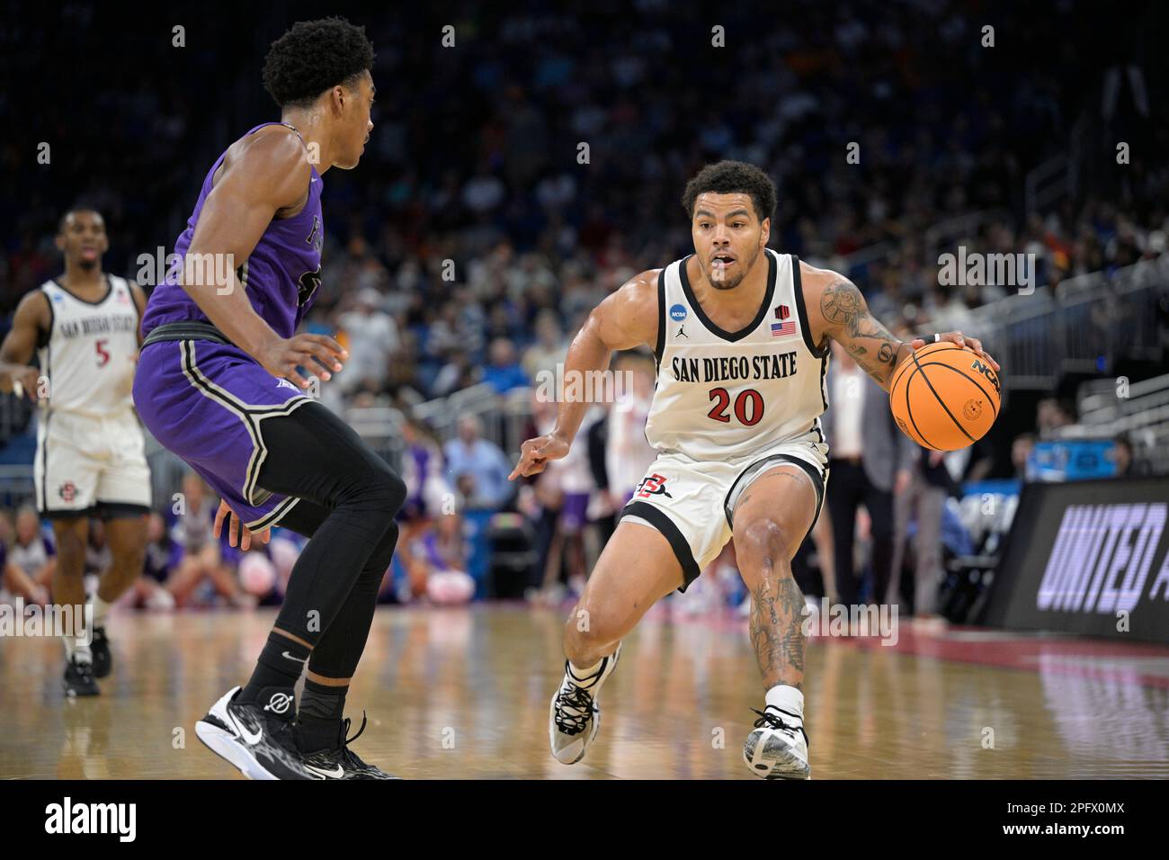San Diego State guard Matt Bradley (20) is defended by Furman guard JP ...