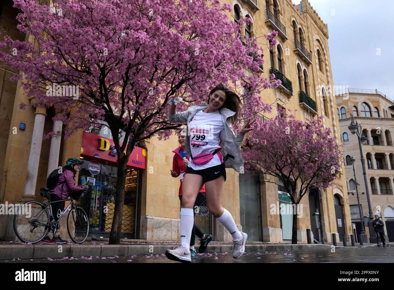 A Lebanese runner cheers as she competes in the Women's Race in Beirut ...
