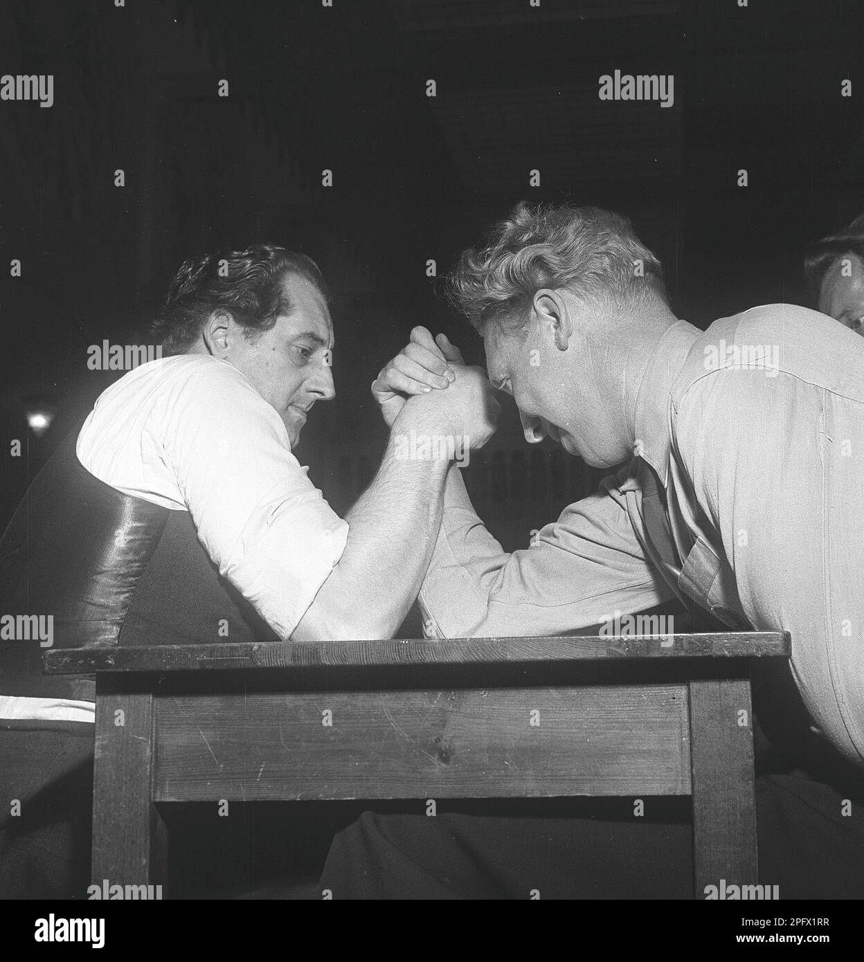 Who's the strongest? An armwrestling match is going on. The two men are ...