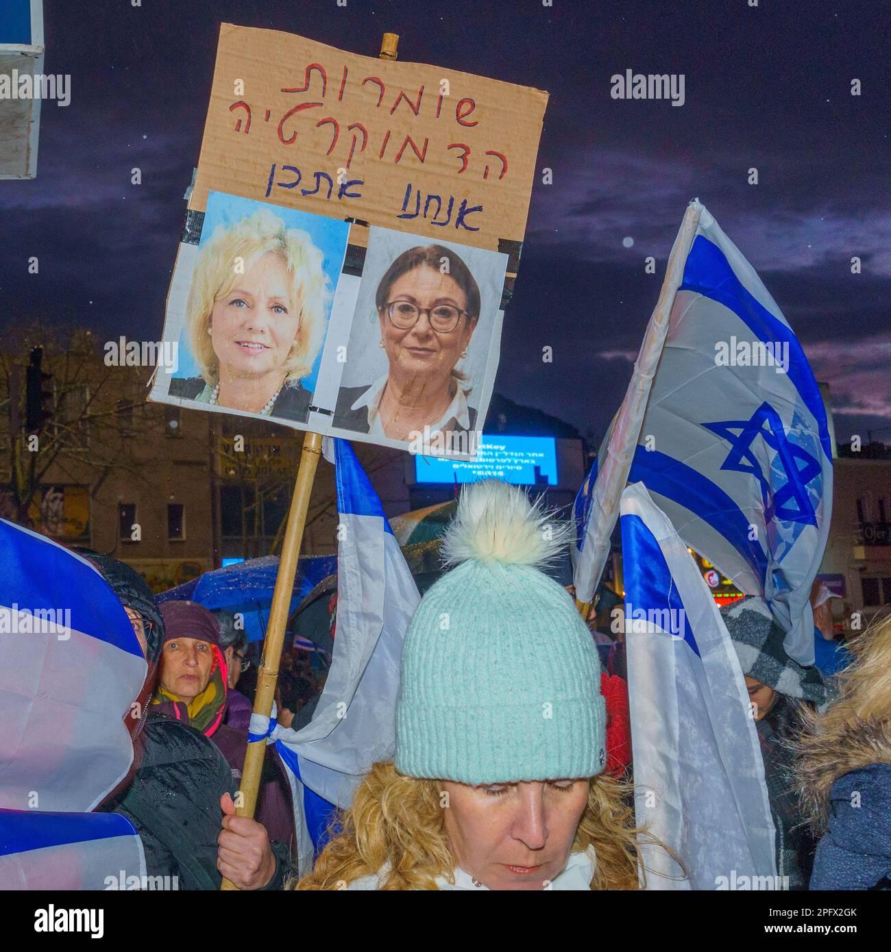 Haifa, Israel - March 18, 2023: Protesters with various signs and flags ...