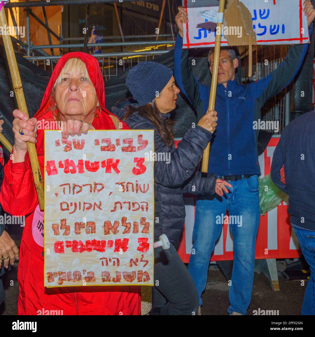 Haifa, Israel - March 18, 2023: Protesters with various signs and flags ...