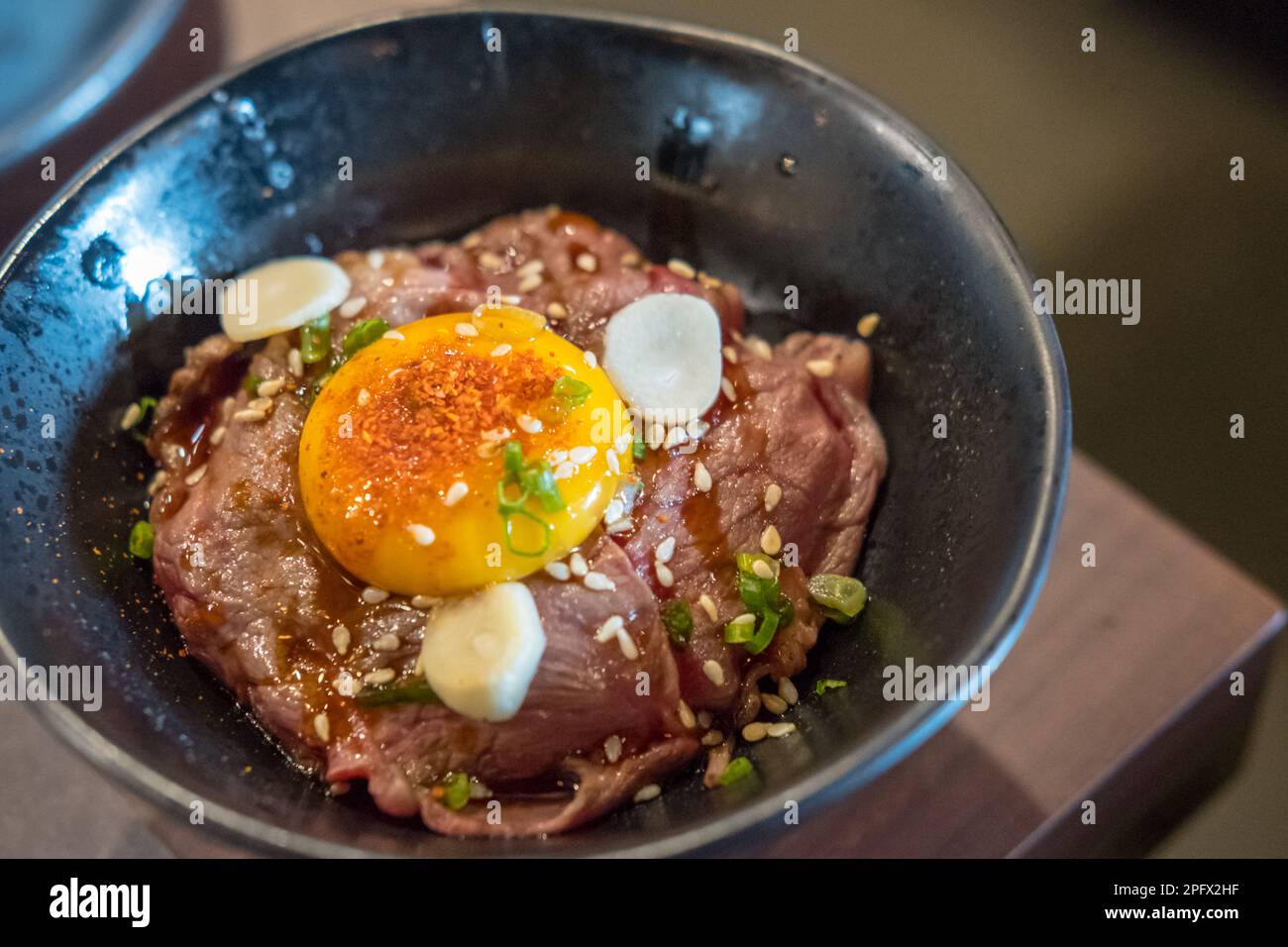 Gyudon, a Japanese dish consisting of a bowl of rice topped with rare ...
