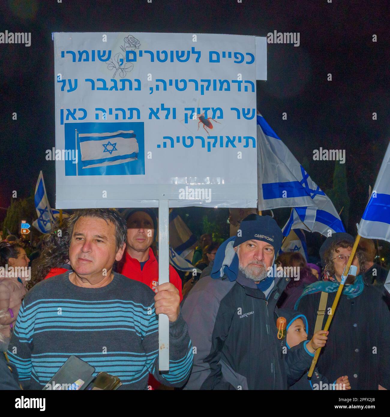 Haifa, Israel - March 18, 2023: Protesters with various signs and flags ...