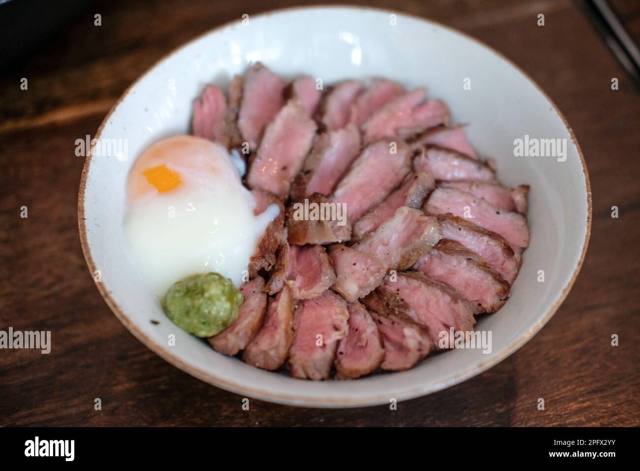 Steak Don, a Japanese dish consisting of a bowl of rice topped with ...
