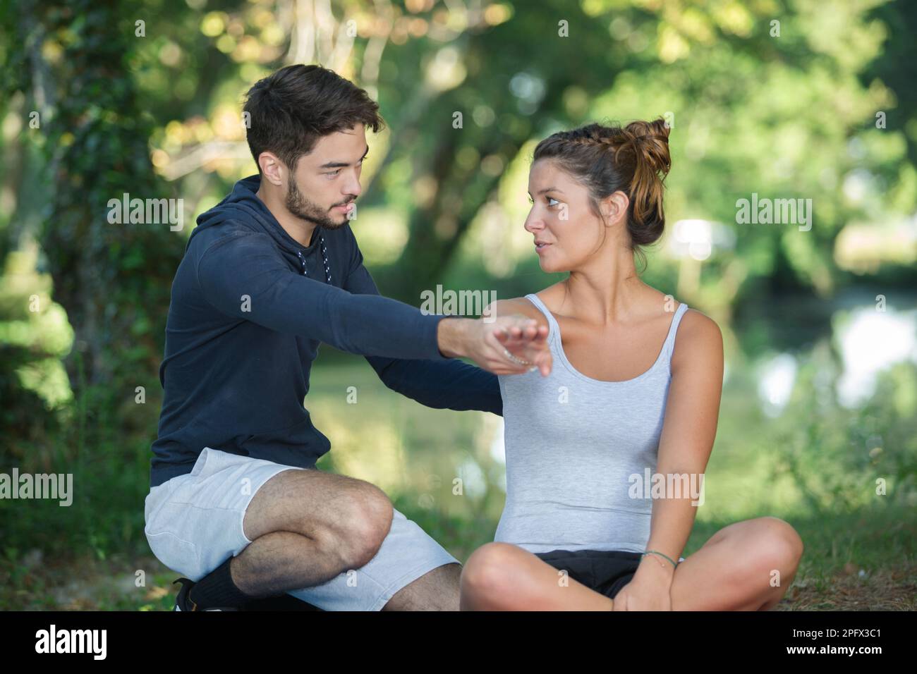 a personal trainer guiding woman Stock Photo - Alamy