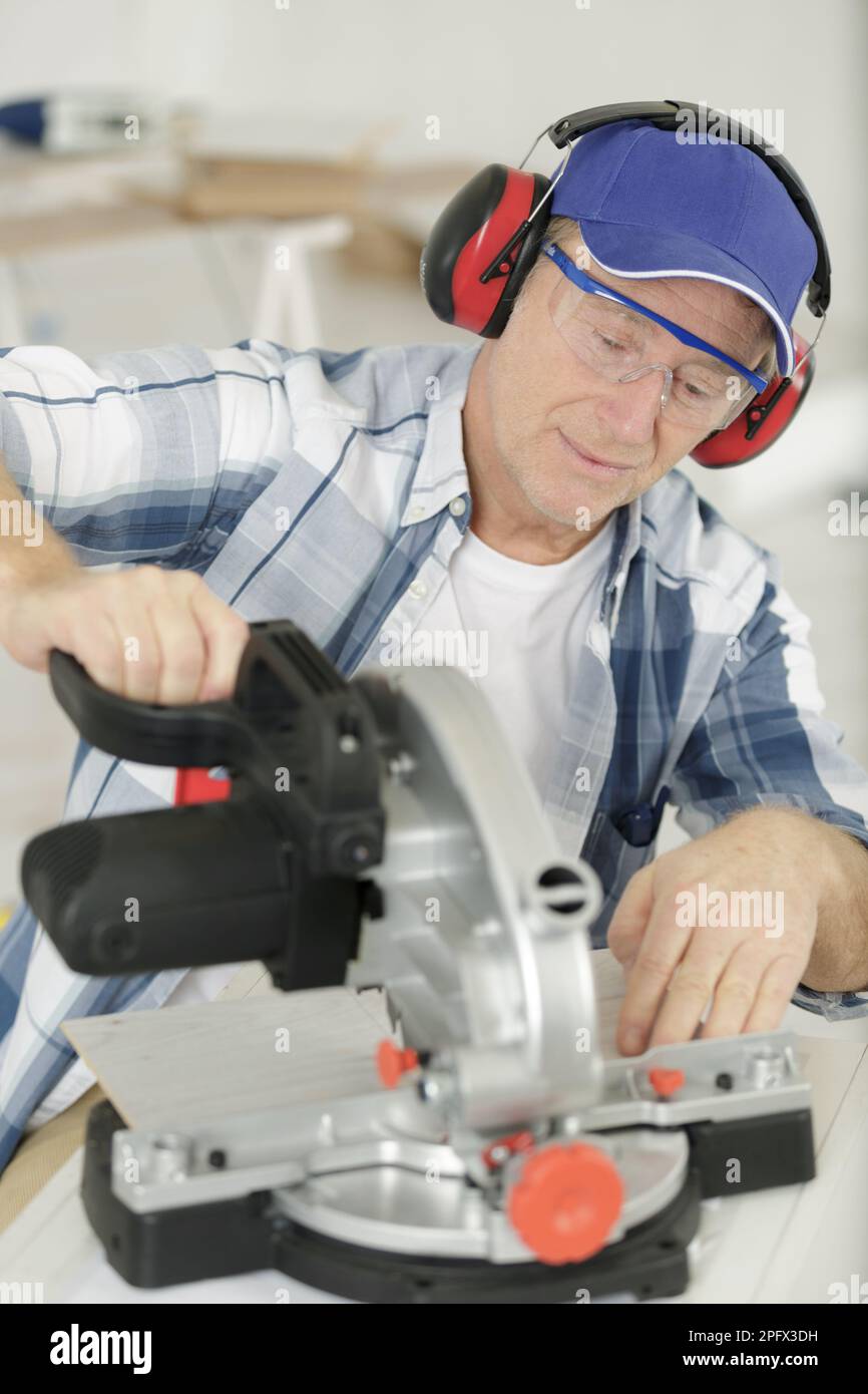 man using industrial circular saw Stock Photo - Alamy