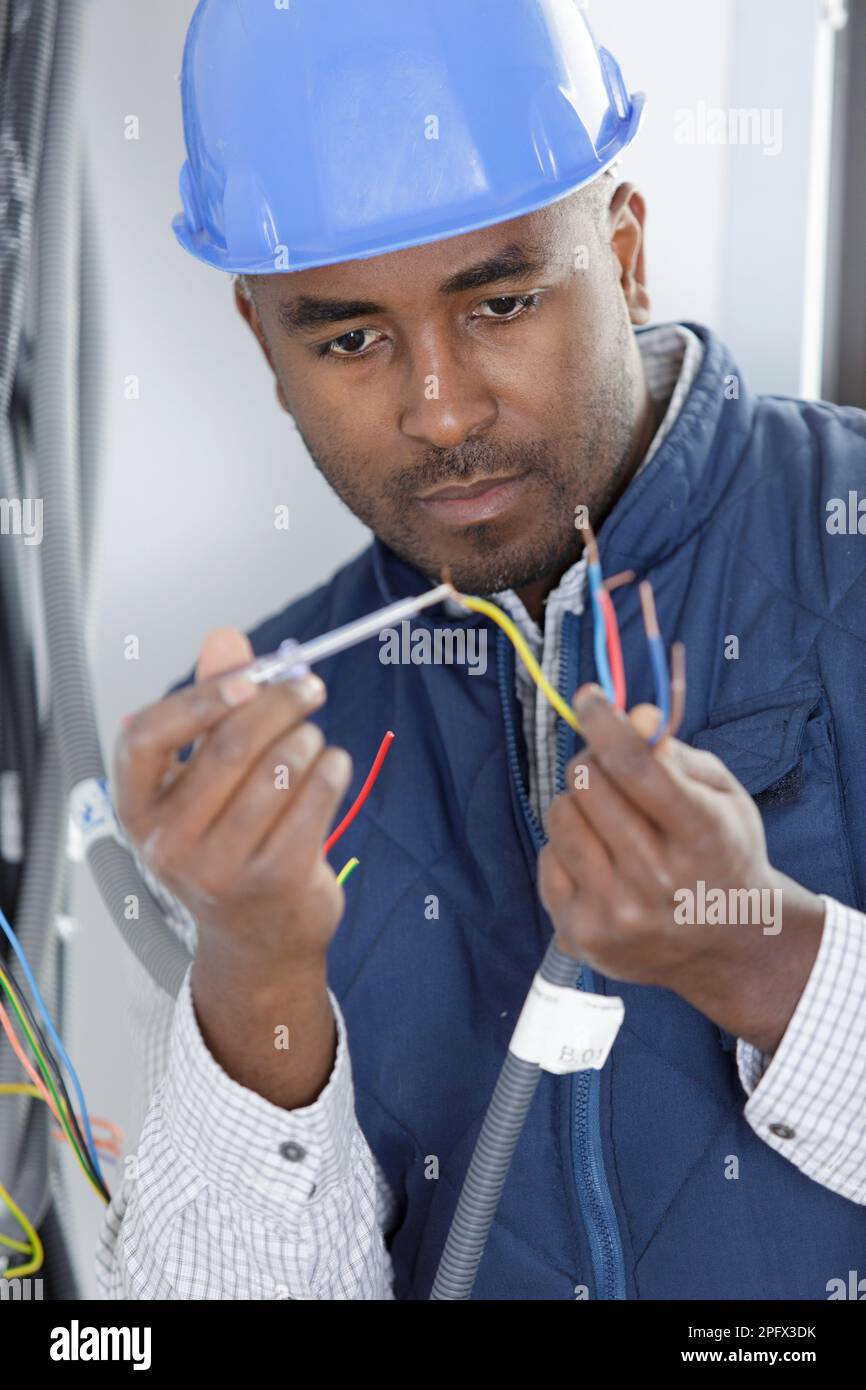 worker fixing wires with screwdriver Stock Photo - Alamy