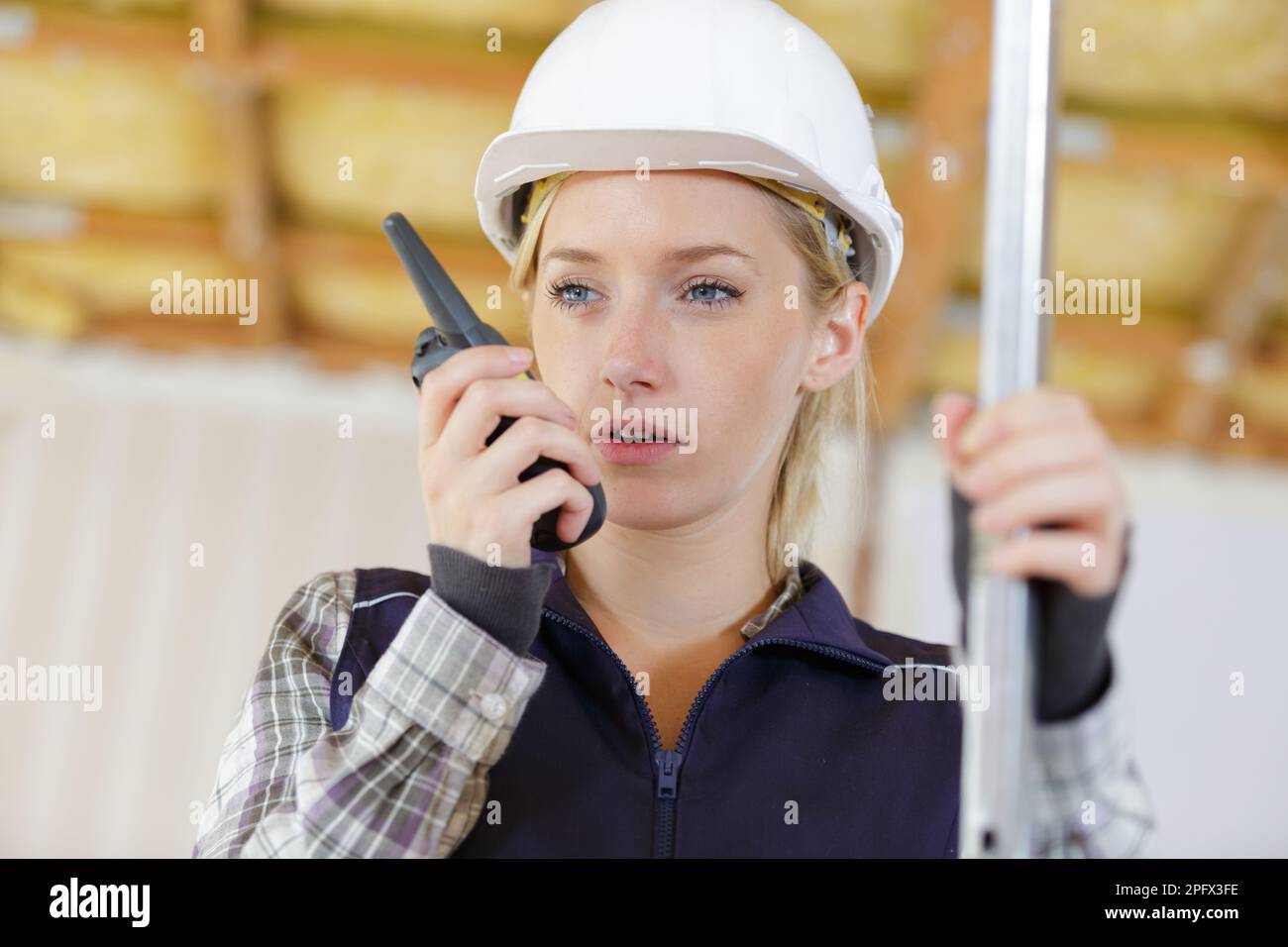 female construction worker using a walkie talkie Stock Photo - Alamy