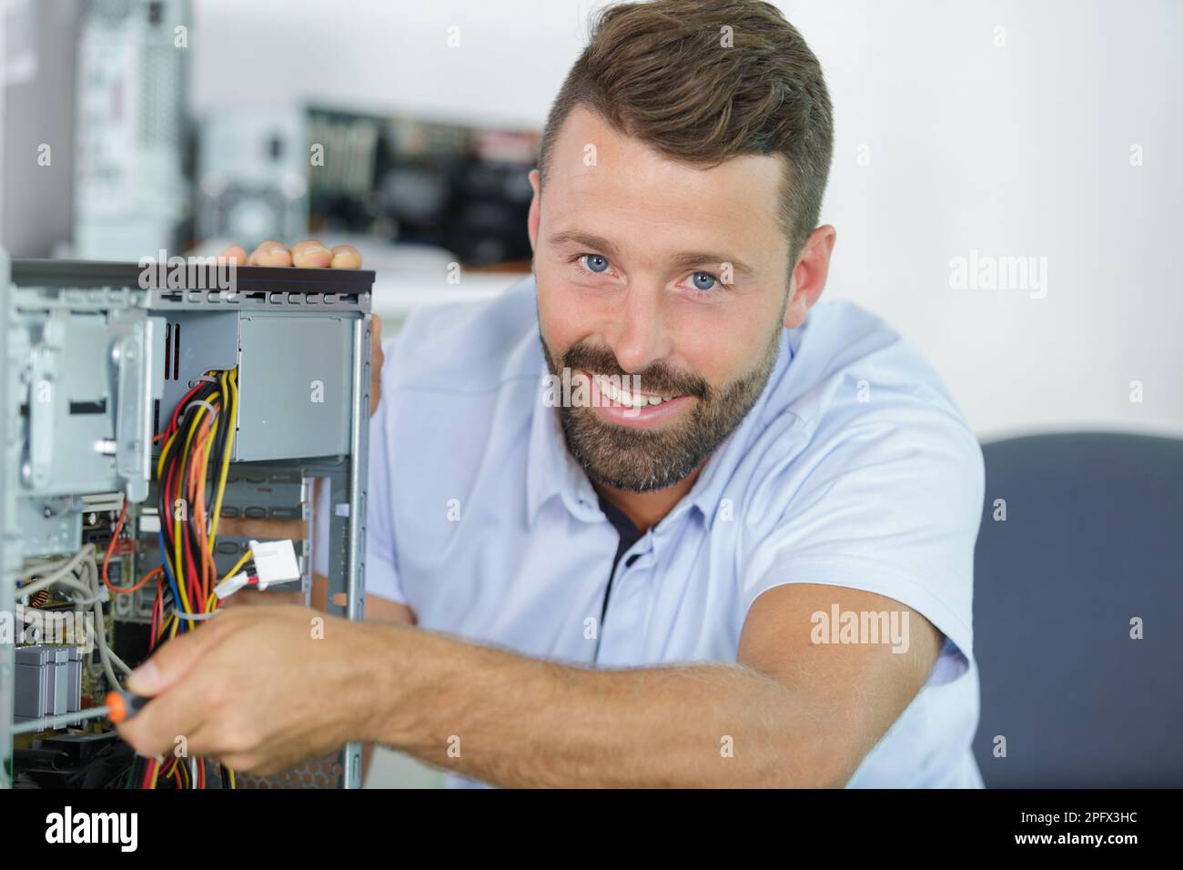 man repairman is trying to fix a pc Stock Photo - Alamy