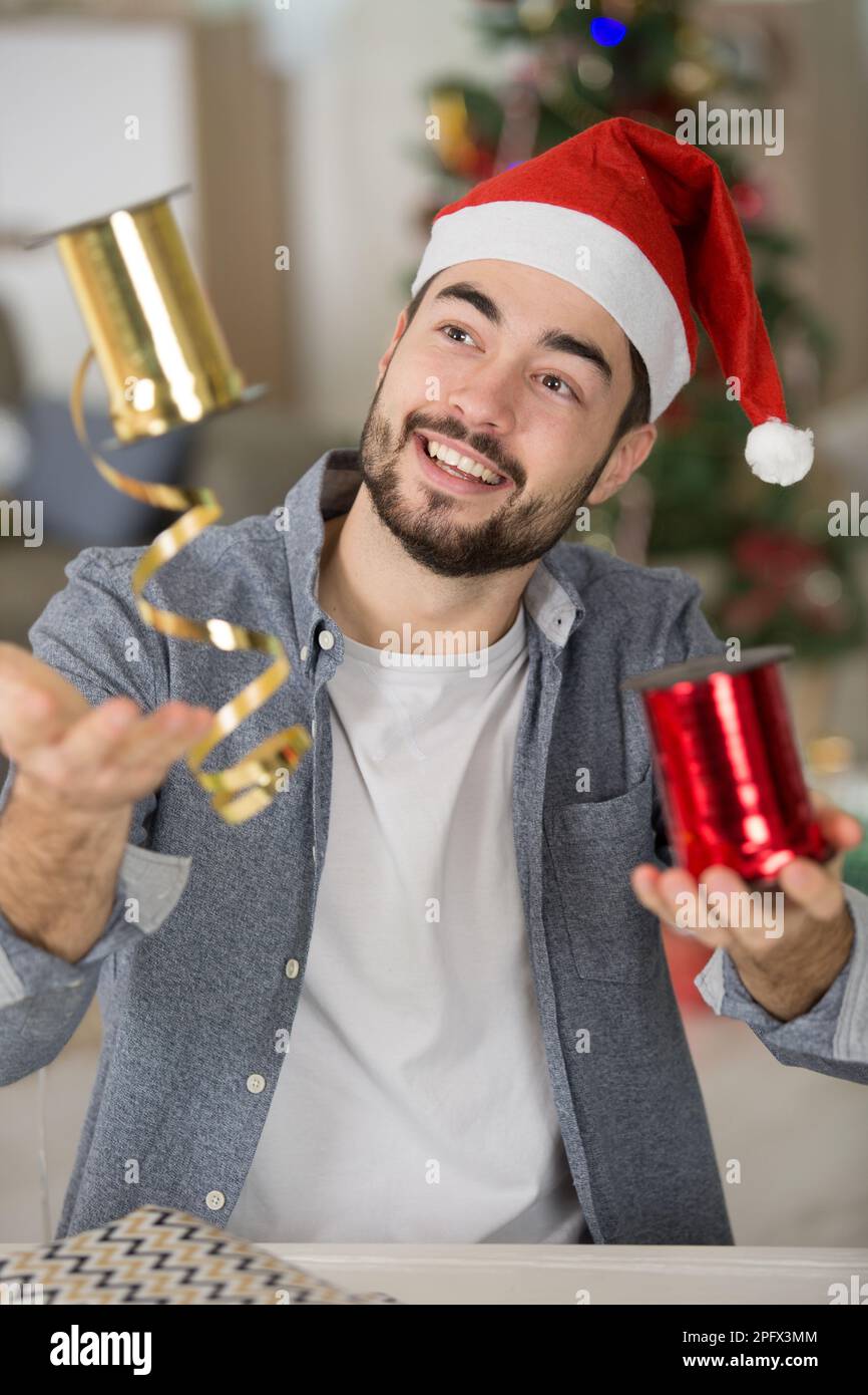 man presents a new years gift in festive packaging Stock Photo - Alamy