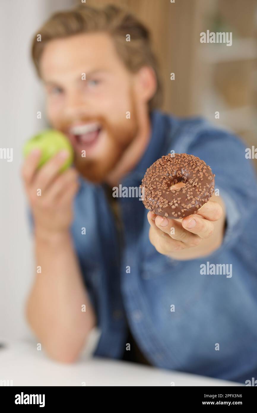 Man eating sweet donut in hi-res stock photography and images - Alamy