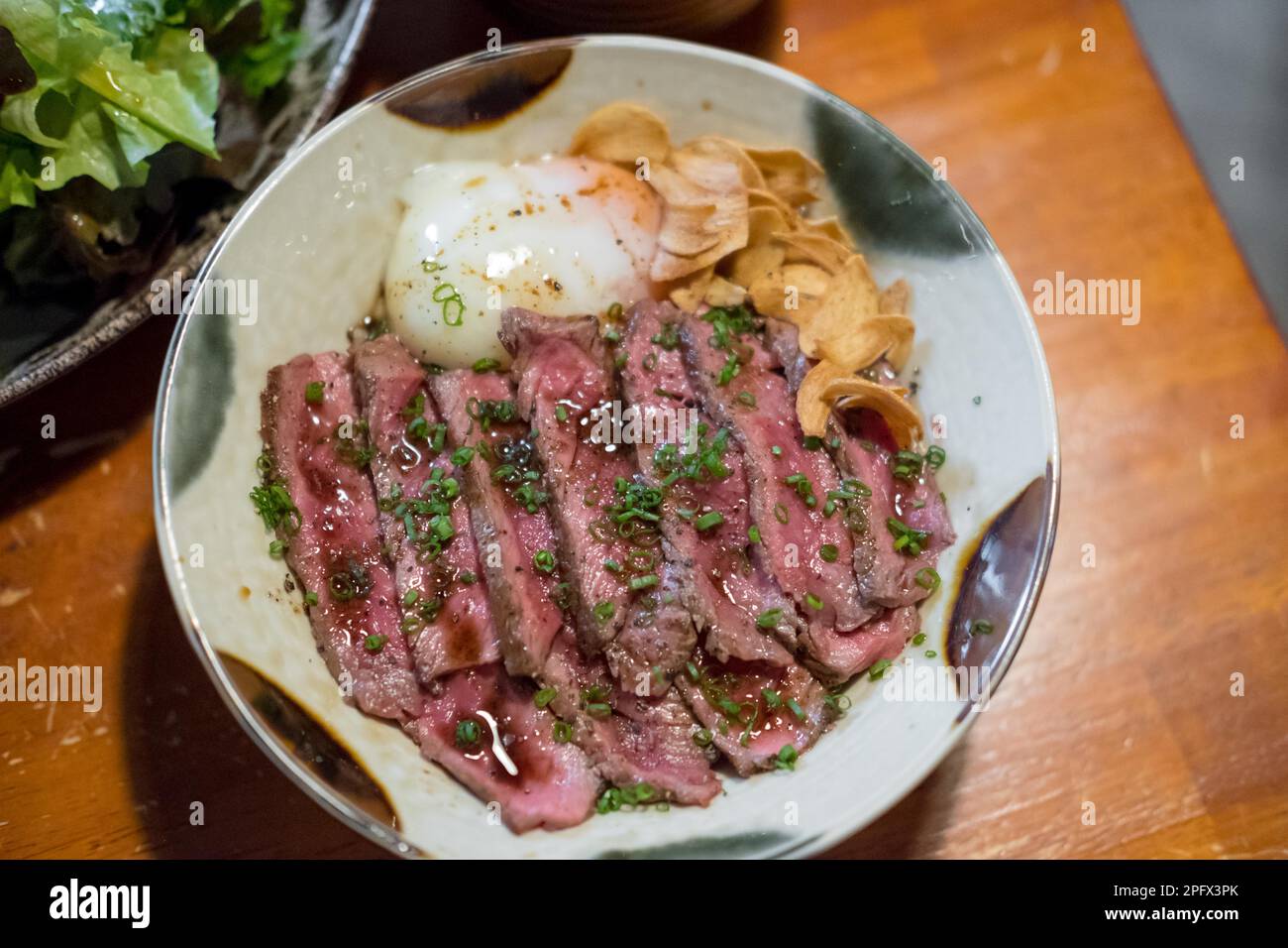 Steak Don, a Japanese dish consisting of a bowl of rice topped with ...