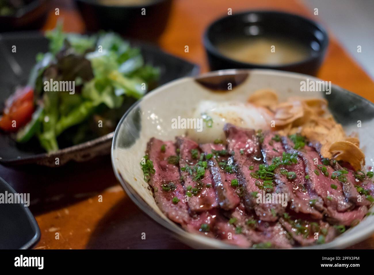 Steak Don, a Japanese dish consisting of a bowl of rice topped with ...