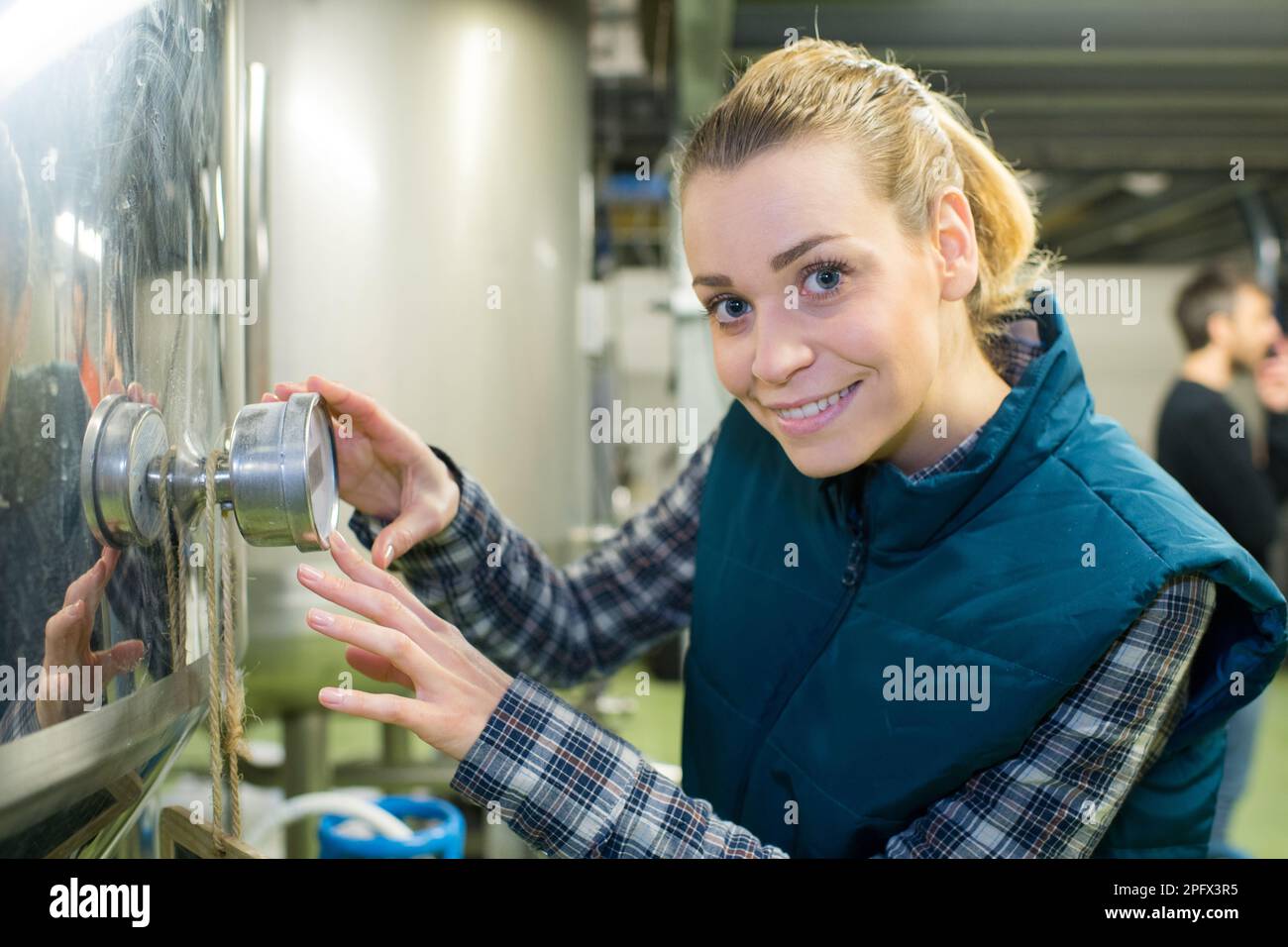 female maintenance worker examining brewery machine at brewery Stock ...