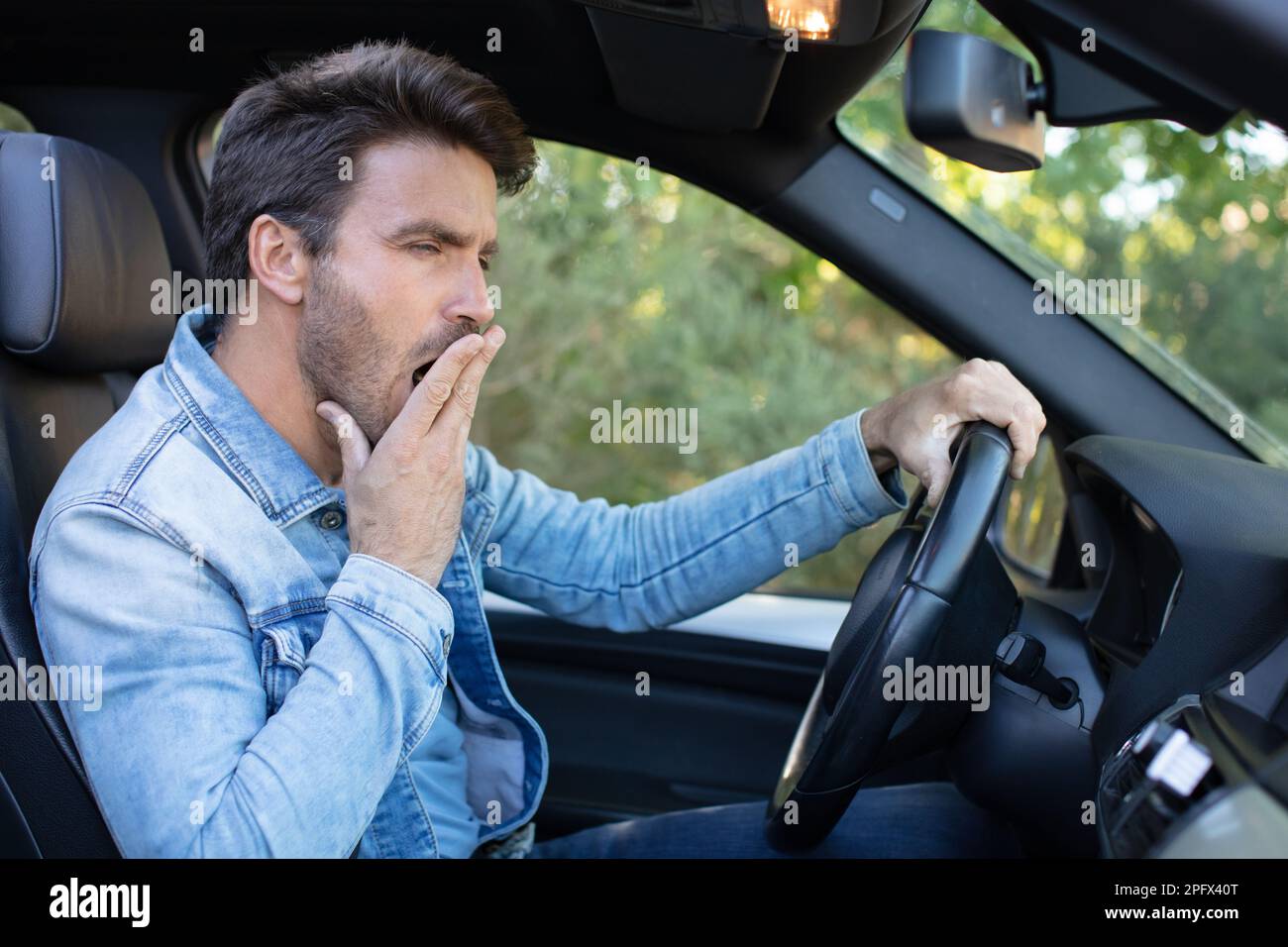 sleepy tired fatigued yawning exhausted man driving his car Stock Photo ...