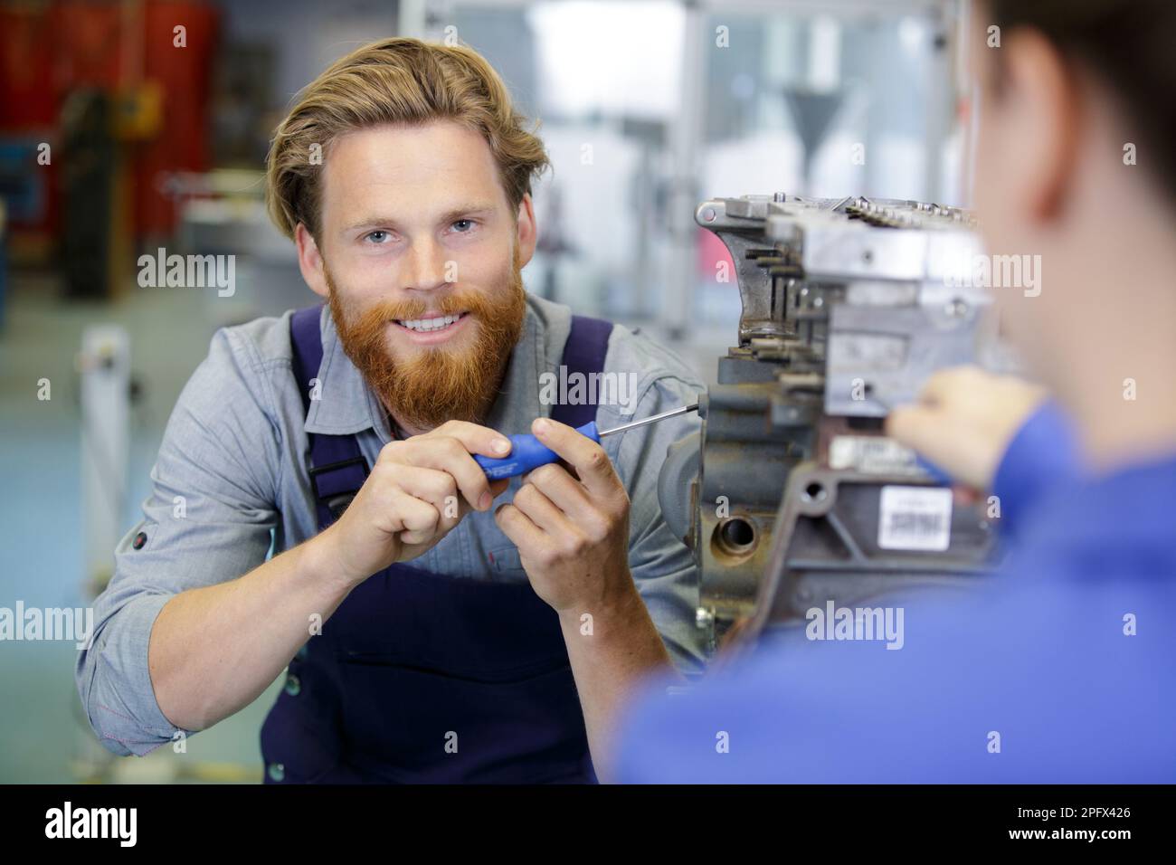 craftsman using a machine in a factory Stock Photo - Alamy