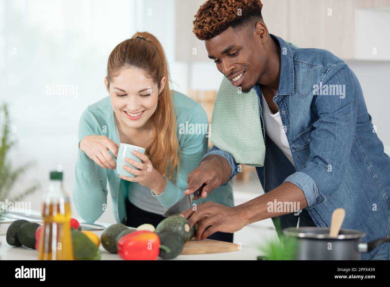 two lovely mixed people cooking together Stock Photo - Alamy