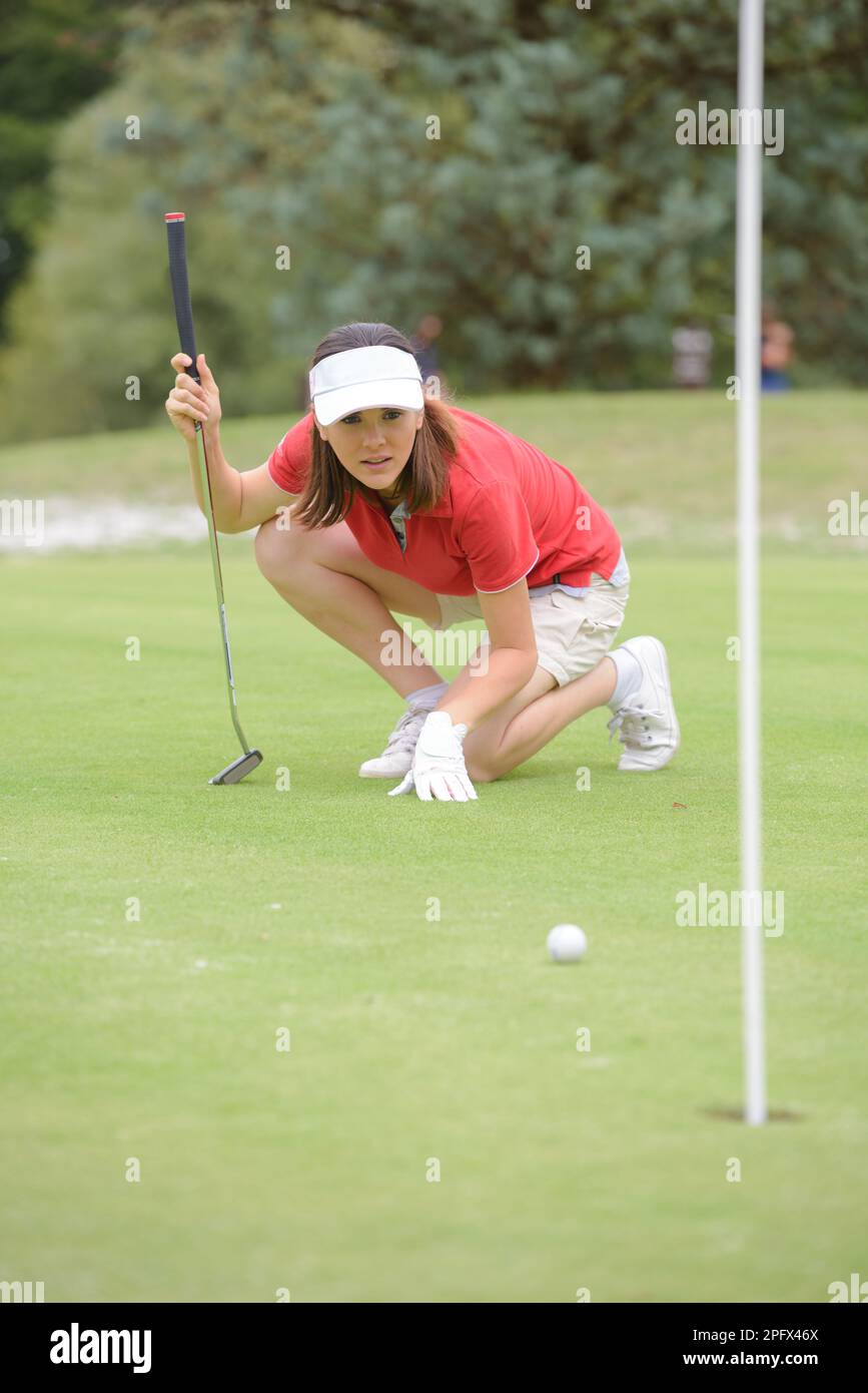 woman golfer feeling disappointed after golf ball missed the hole Stock ...