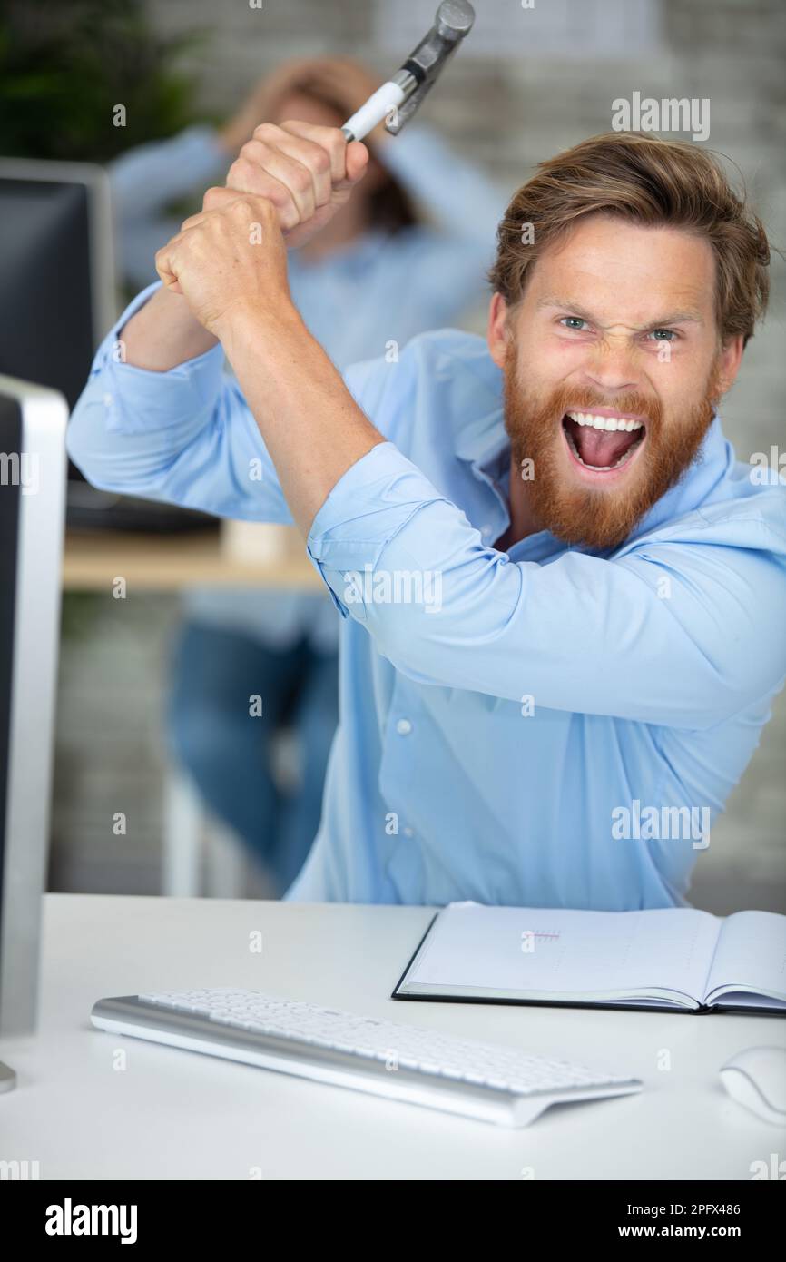 angry man with hammer up in hand Stock Photo - Alamy