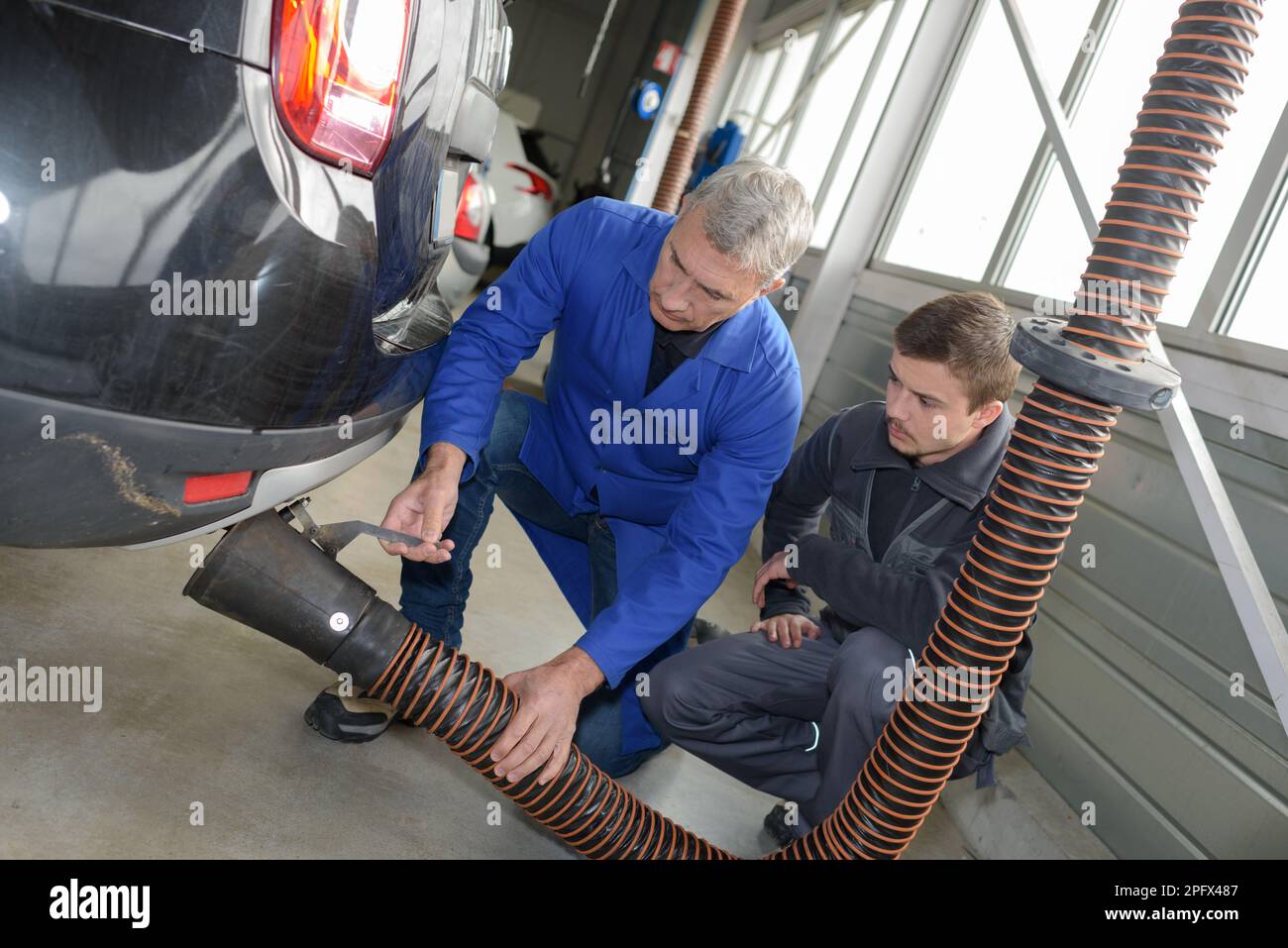 student with instructor repairing a car during apprenticeship Stock ...