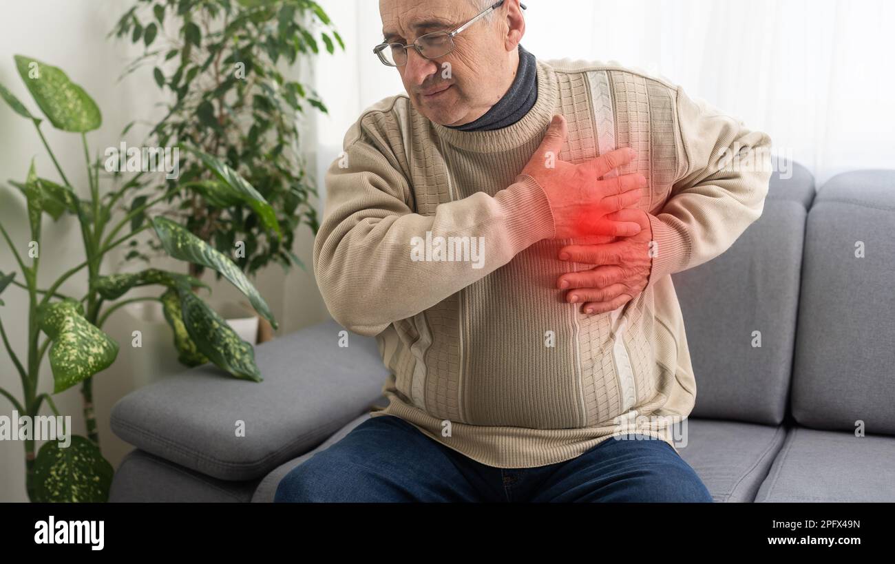 Good looking old man having chest pain heart attack or cardiac arrest ...