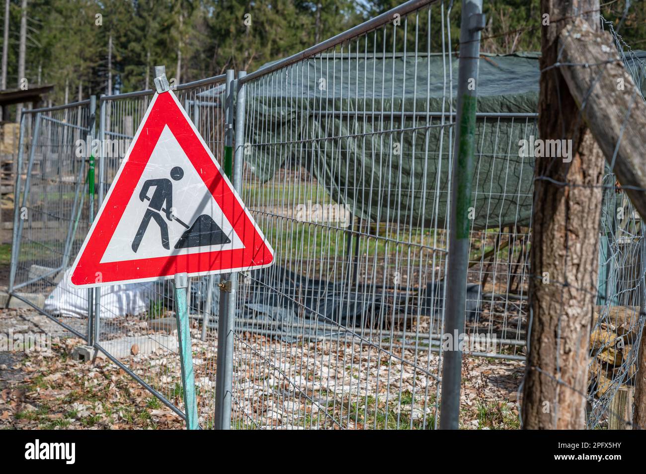 Construction area with german red triangle shape sign standing next to ...