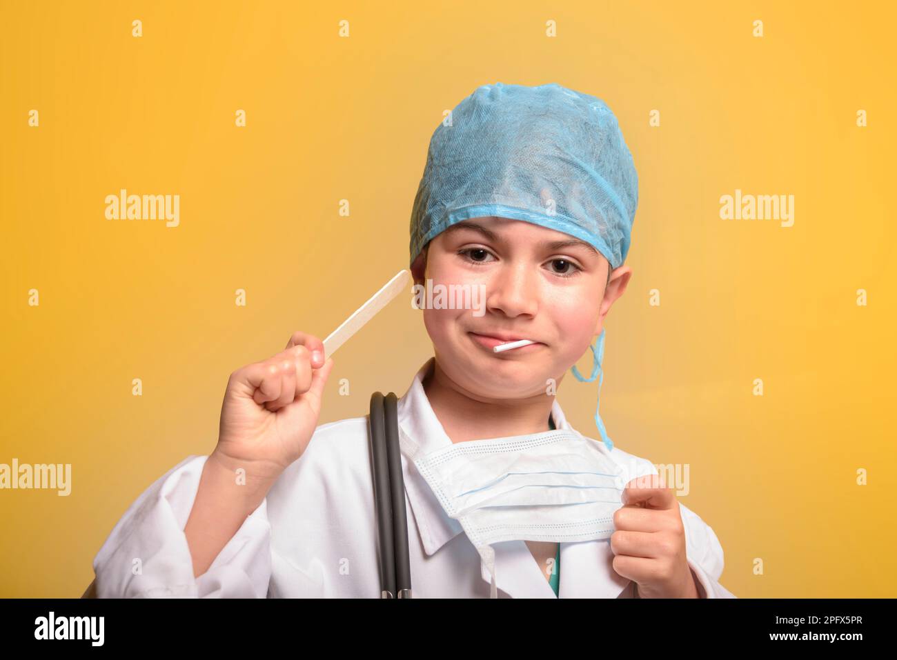 Smiling child boy doctor on yellow background. Male doc in white ...