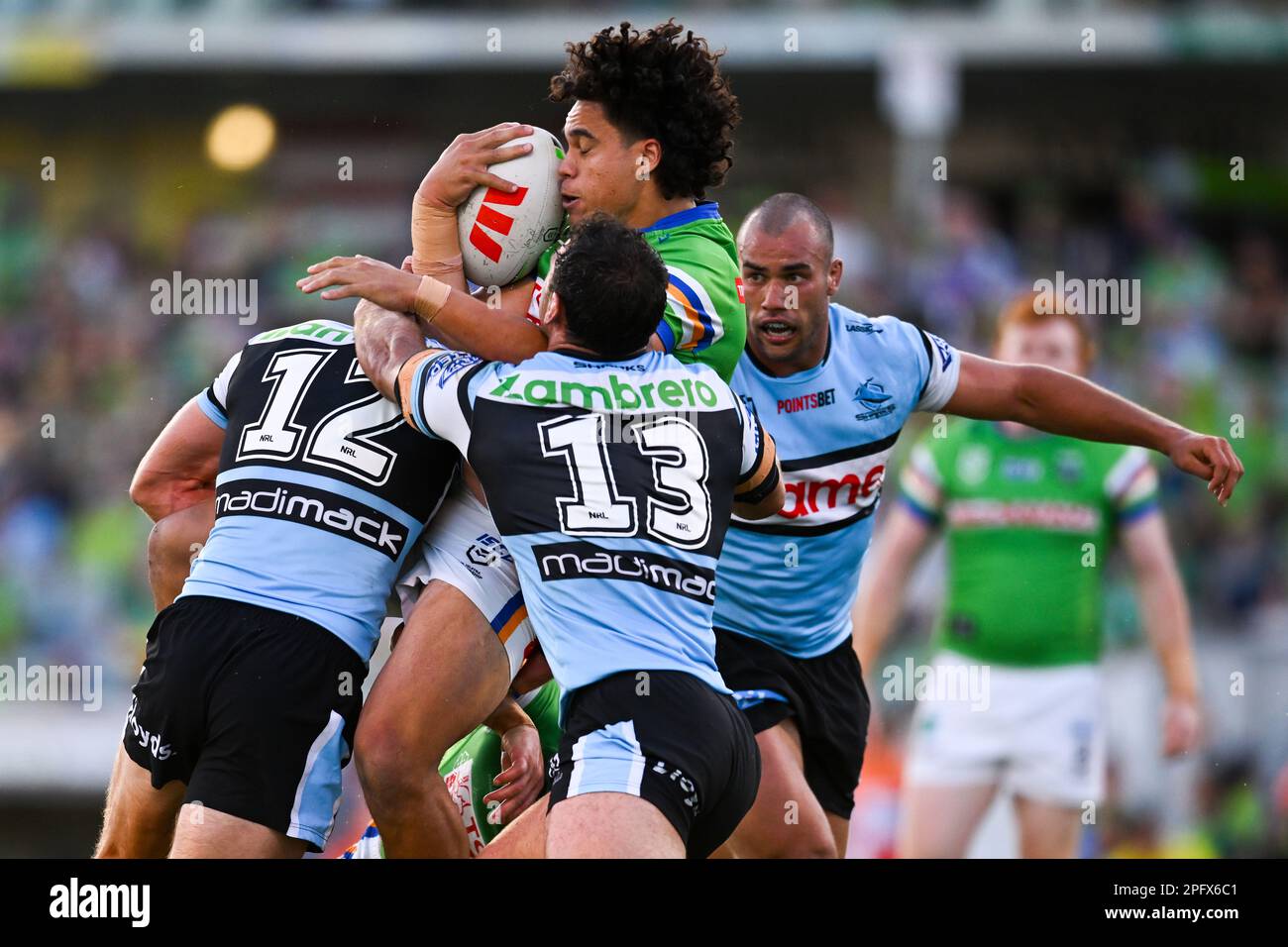 Pasami Saulo of the Raiders is tackled by Teig Wilton of the Sharks ...