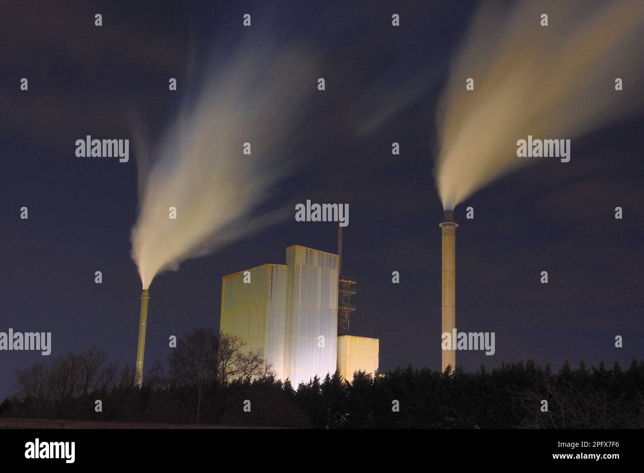 Night time industrial view with factory chimneys and smoke Stock Photo ...