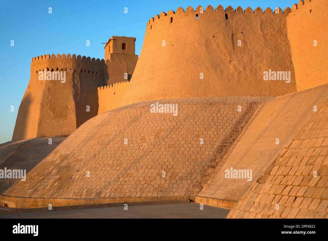 Sunset at the walls of the ancient fortress of Kunya Ark. Khiva, Ichan ...