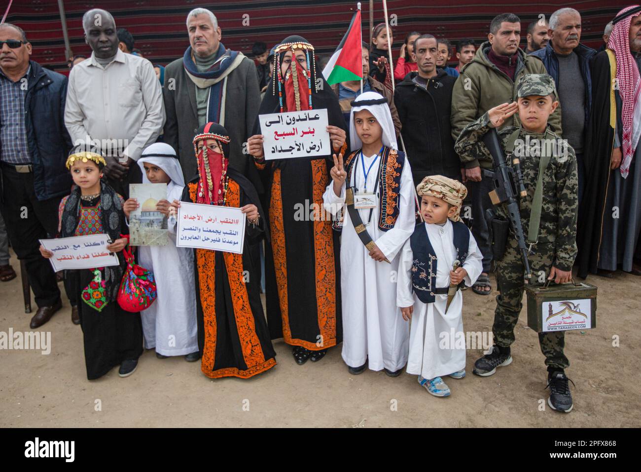 Gaza, Palestine. 18th Mar, 2023. Palestinians hold flags and placard ...