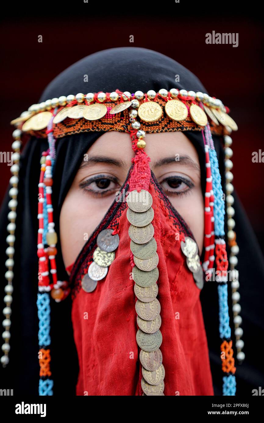 Gaza, Palestine. 18th Mar, 2023. A Palestinian woman wears the ...