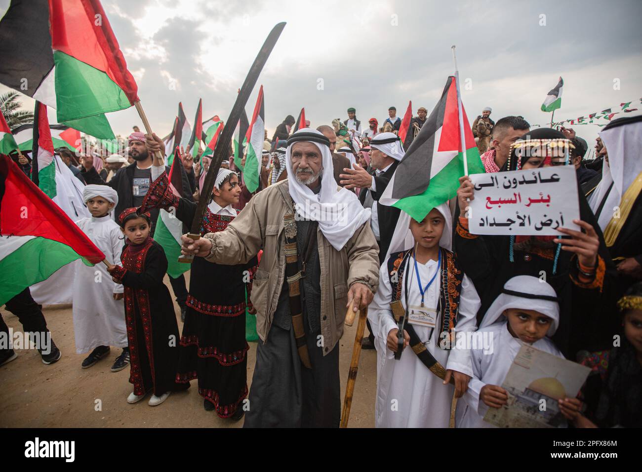 Gaza, Palestine. 18th Mar, 2023. Palestinians hold flags and placard ...