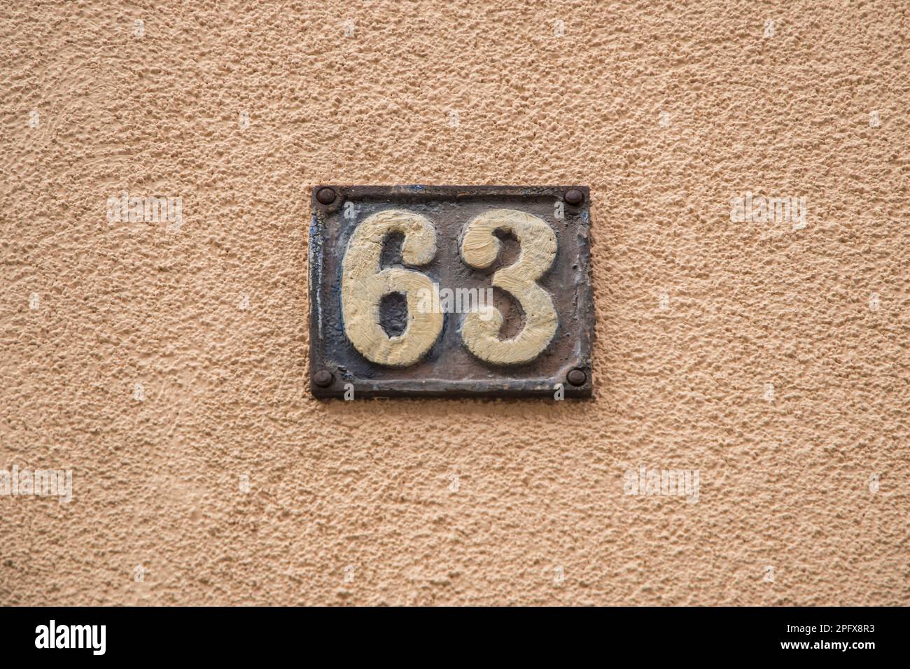 Old retro weathered cast iron plate with number 63 Stock Photo - Alamy