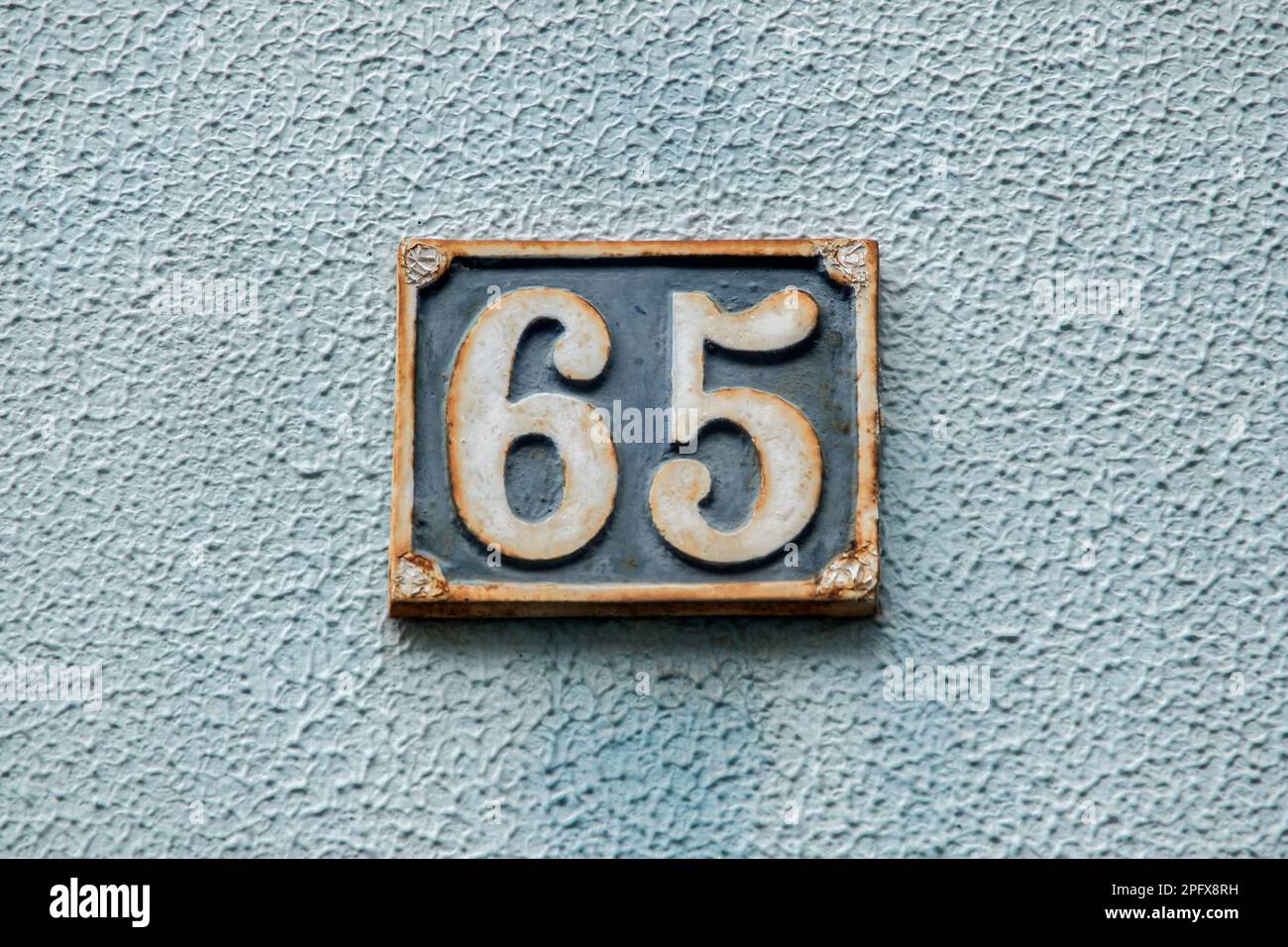 Old retro weathered cast iron plate with number 65 Stock Photo - Alamy