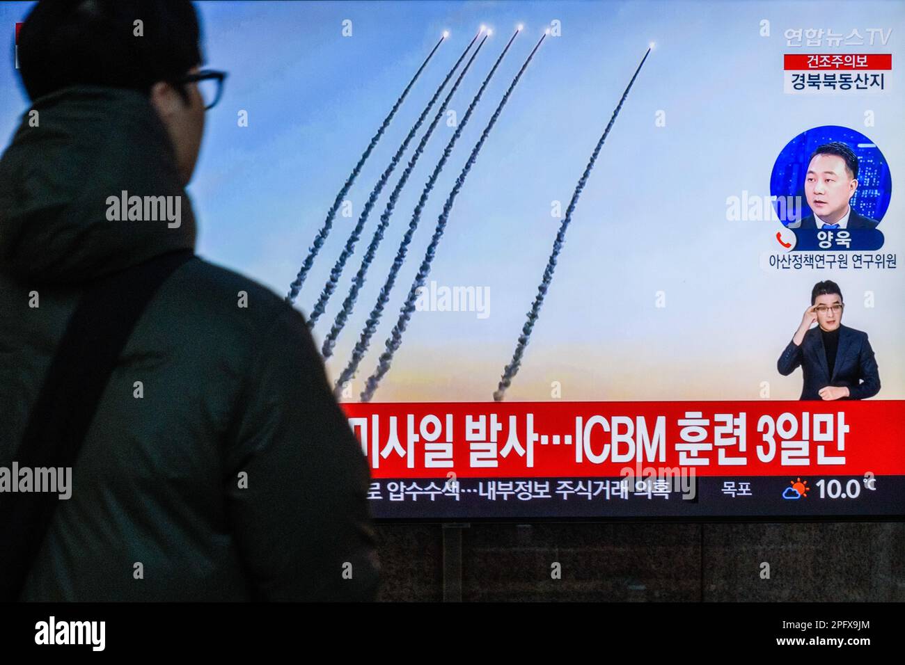 A TV screen shows file footage of North Korea's missile launch during a ...