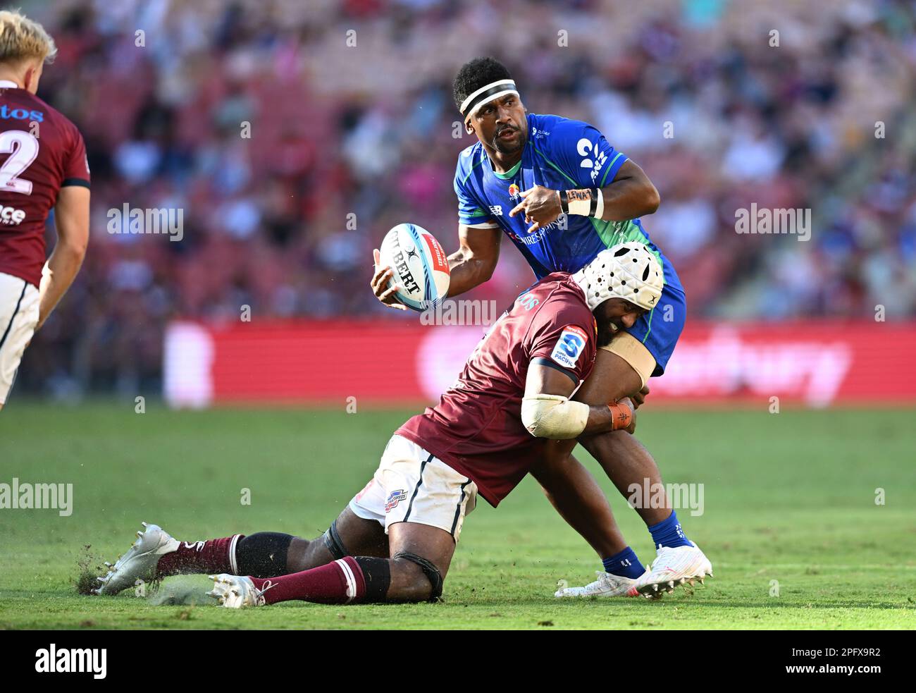 Kalaveti Ravouvou of the Fijian Drua is tackled by Seru Uru of the Reds ...