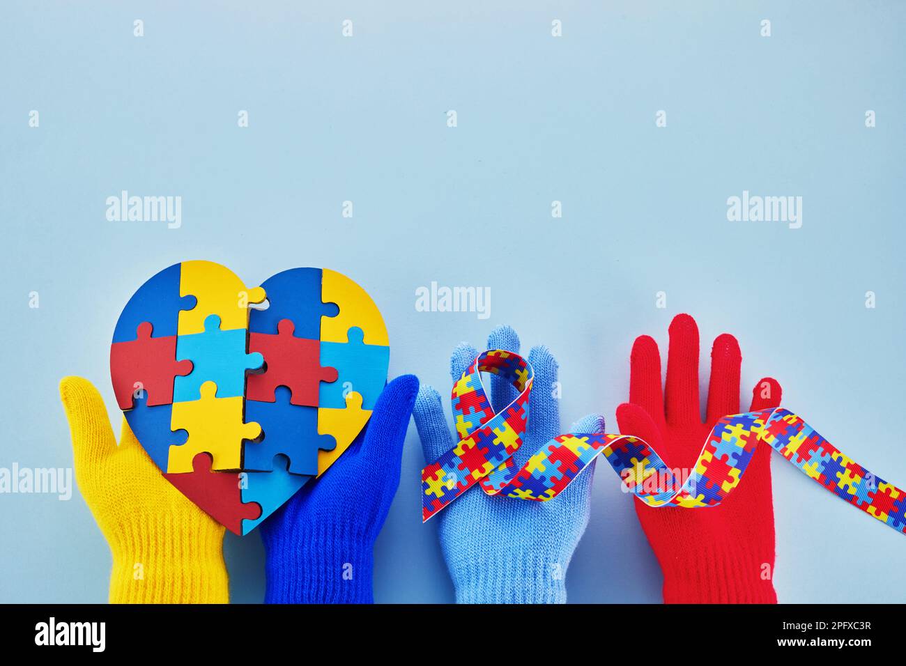 Hands holding puzzle ribbon for World Autism Awareness Day Stock Photo ...