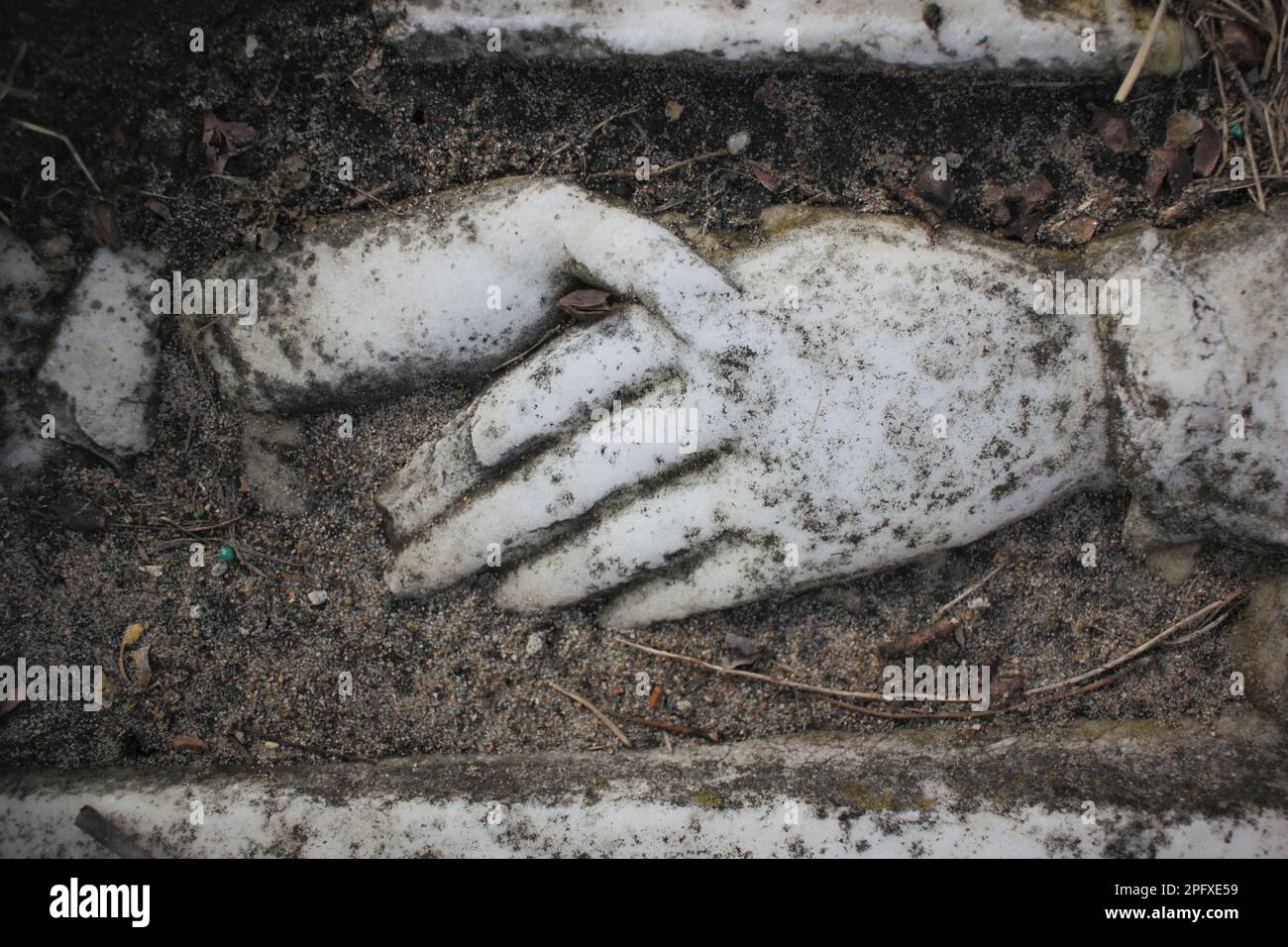 Two hands shaking hands and carved into the natural stone wall Stock ...