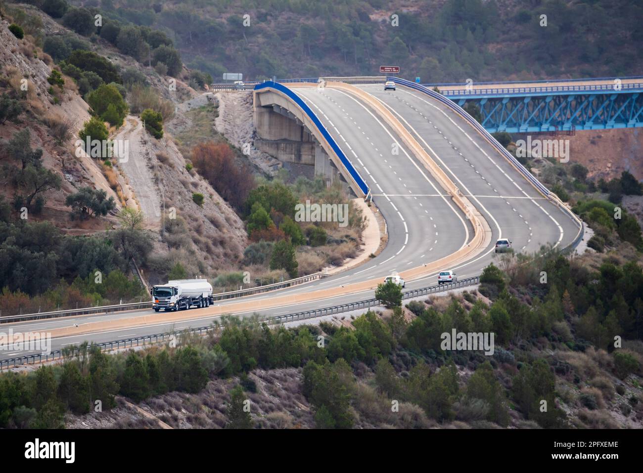 Fuel tanker truck driving on a highway with bridges Stock Photo - Alamy